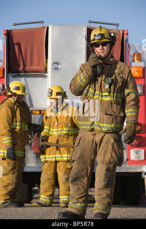 A firefighter talking on the radio emergency scene Stock Photo - Alamy