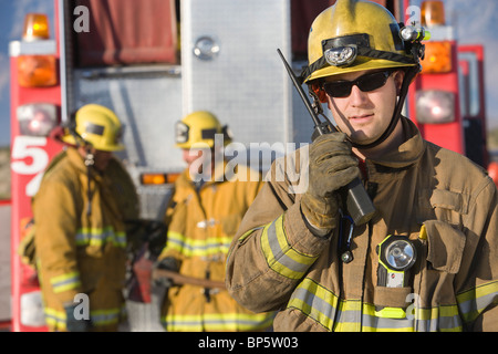 Firefighter holding two-way radio Stock Photo - Alamy