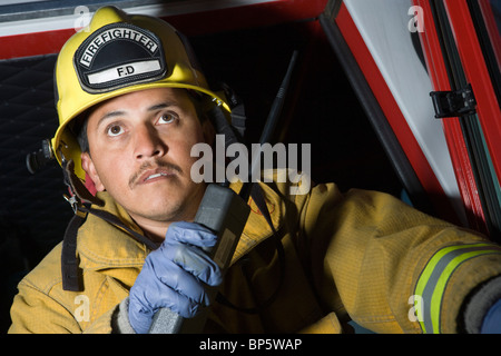 Firefighter holding two-way radio Stock Photo - Alamy