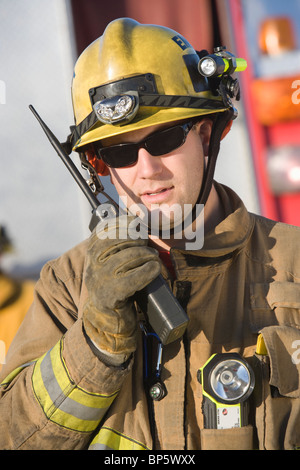 A firefighter talking on the radio emergency scene Stock Photo - Alamy