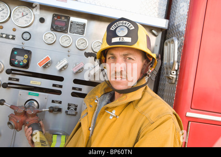 Firefighter operating engine Stock Photo - Alamy