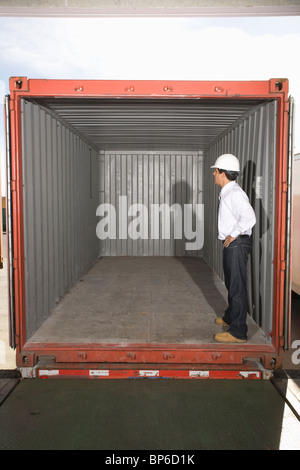 The empty container inside warehouse on shipment area Stock Photo - Alamy
