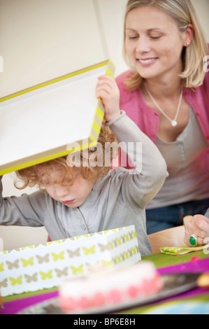 One little boy opening gift box. Child receiving birthday present in ...