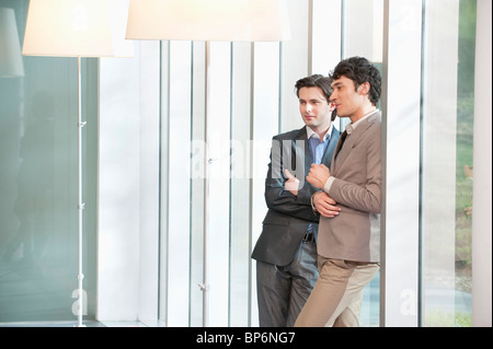 TWO MEN ARE STANDING TOGETHER IN A OFFICE TAKING A PICTURE Stock Photo ...