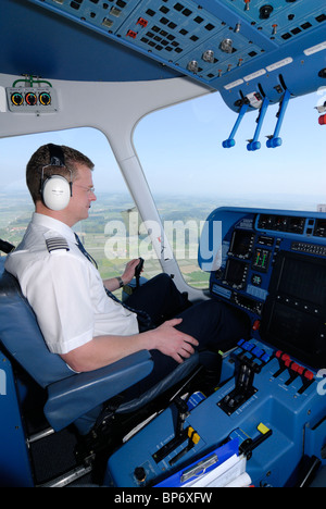 Pilot in cockpit flying the airship dirigible Zeppelin NT over ...