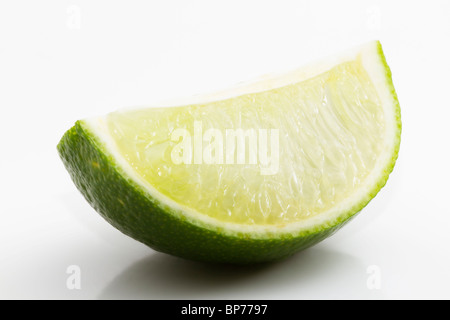 quarter lime diagonal on white background Stock Photo - Alamy