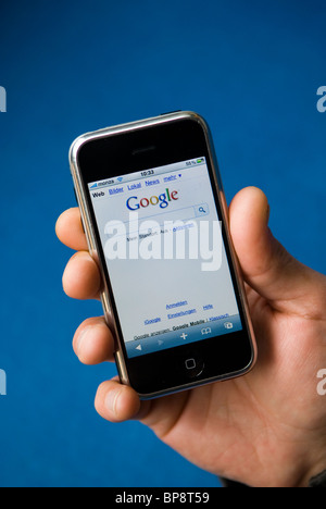 Man holding iPhone 3Gs with google earth maps Stock Photo - Alamy