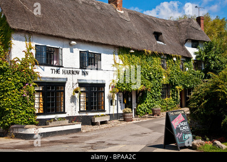 A typical traditional English country thatched house or cottage with ...