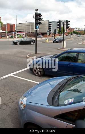 Cars waiting at traffic lights in a city centre in the uk Stock Photo ...