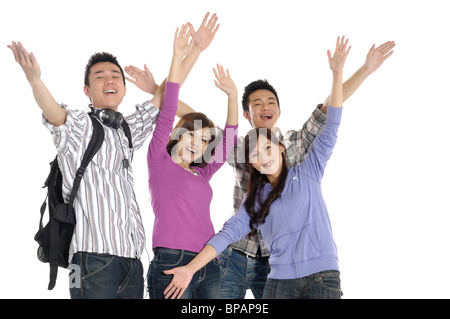 Front view of three excited students receiving good news on line in a ...