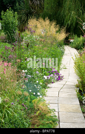 A paving garden path and flower border Stock Photo - Alamy