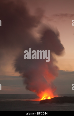 Lava flowing into the ocean at sunset Stock Photo - Alamy