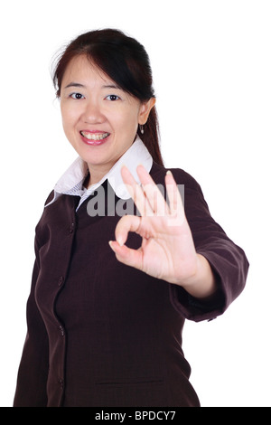 Smiling Businesswoman giving Okay Sign In Front of Vacant Office ...