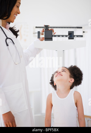Growth of a girl. Pediatrician doctor measuring the height of a little ...