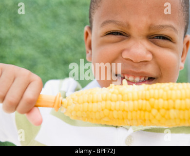 African boy eating corn Stock Photo - Alamy