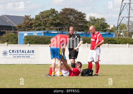 Football / soccer player receiving treatment for injury of cut above ...