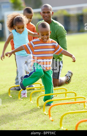 Boy running across the grass Stock Photo - Alamy