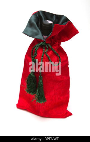 Bottle of red wine with red satin on a black background. Top view Stock ...