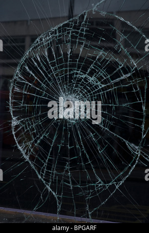 Window shattered by a stone, West London UK Stock Photo - Alamy