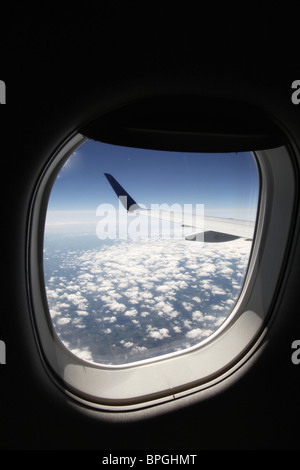 View of clouds from an airplane flying at a high altitude Stock Photo ...