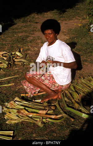 South Pacific Islander woman preparing traditional food in her woven ...