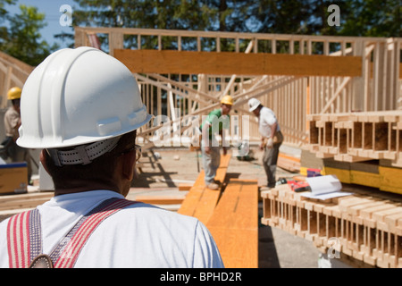 Carpenters working on a lamination beam at a construction site Stock ...