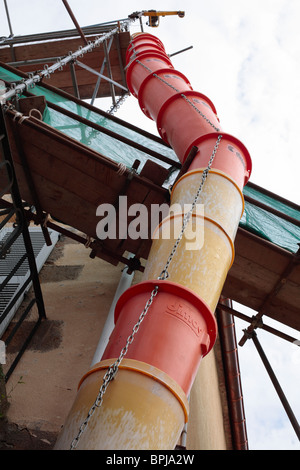 Builders scaffolding waste chute Stock Photo - Alamy
