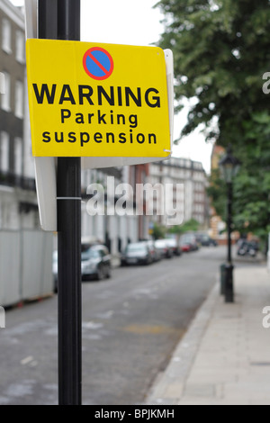 Yellow warning sign: "Parking Suspended Stock Photo - Alamy