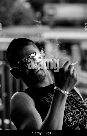 Young Mauritian male smoking, Flic en Flac, Mauritius Stock Photo - Alamy
