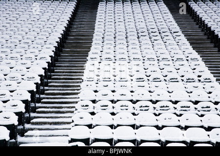 Stadium seats are covered in snow before an NFL football game between ...