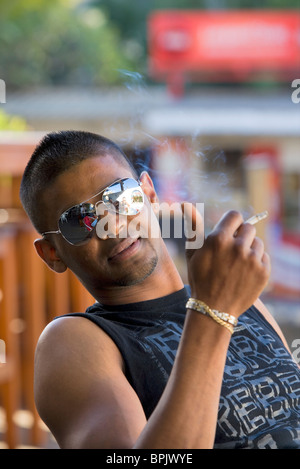 Young Mauritian male smoking, Flic en Flac, Mauritius Stock Photo - Alamy