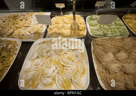 Varieties of fresh made pasta on display at an italian supermarket ...