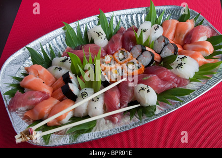 Different Sushi served on japanese knife on a black slate plate . flat ...