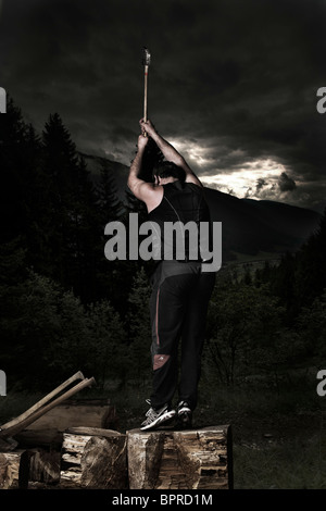 A man chops a tree trunk with an axe during traditional rural sport ...