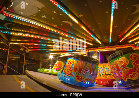 Bright lights of the Waltzer ride of a funfair with a slow shutter ...