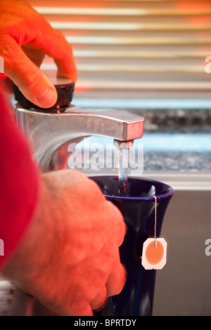 afternoon tea image with black tea,donuts and beautiful teapot and cup ...