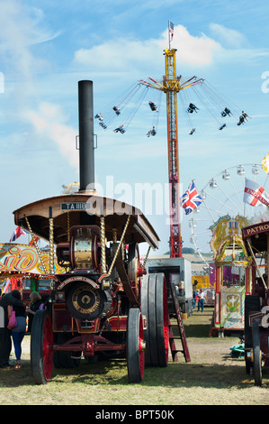 Showmans Traction Engine in front of a steam fairground ride at the ...