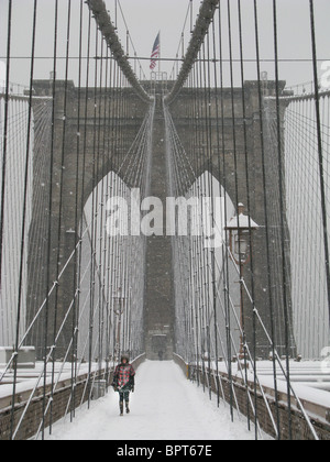 Brooklyn Bridge at snow storm, a view to Manhattan buildings in fog ...