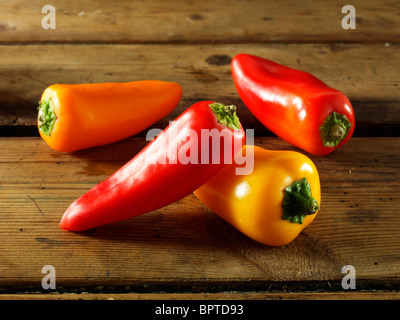 red, orange and yellow mini peppers isolated on grey Stock Photo - Alamy