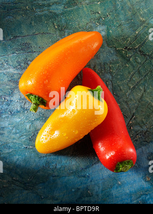 red, orange and yellow mini peppers separately isolated on grey Stock ...