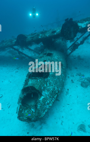 Cameraman filming the wreck of a PBY Catalina seaplane or flying boat ...
