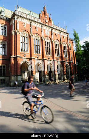 Cyclist passing the Collegium Novum This neo Gothic building was built ...