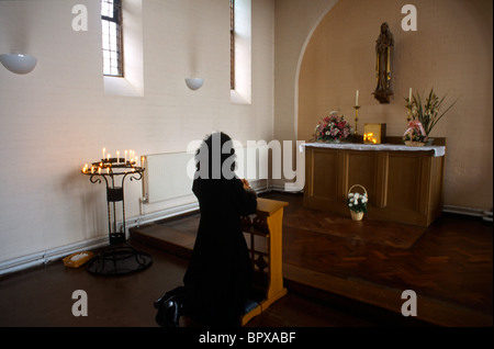 St Cecilias Roman Catholic Cheam Woman Praying Alone In Church looking ...