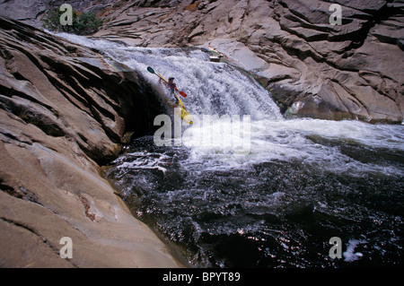 A man goes over a waterfall in a kayak Stock Photo - Alamy