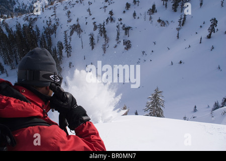 A ski patroller throwing explosives for avalanche control at Squaw ...