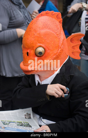 Man with goldfish head reading a newspaper, promoting a Fringe show in ...