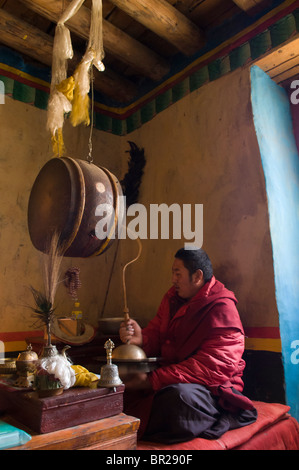 Tibetan Buddhist monk chants, plays drum and cymbals, Juli Monastery ...