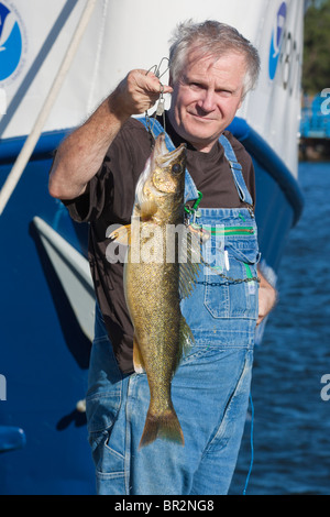 Old photo of fisherman holding a caught fish Stock Photo - Alamy