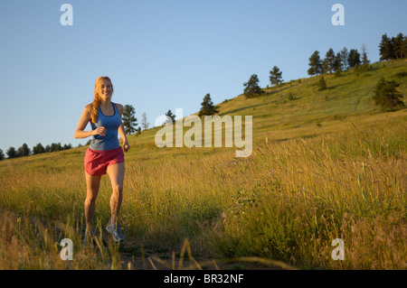 A woman trail runs just after sunrise in Boulder, Colorado Stock Photo ...