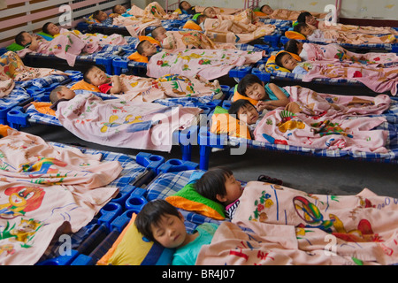 Children make their beds in a school dormitory in Amuria, Uganda, East ...